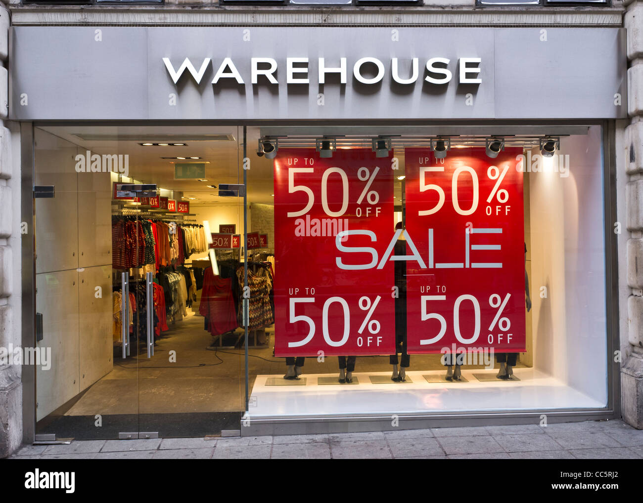 Warehouse womans retailer shop facade displaying 50% sale signs Stock ...