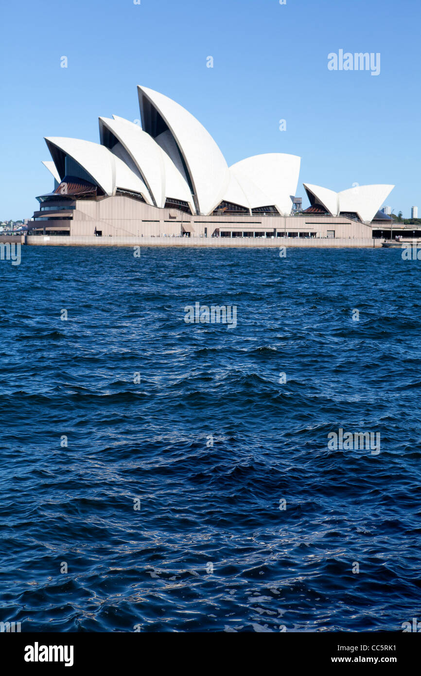 A view of the Sydney Opera House with a bright blue sky and Sydney ...
