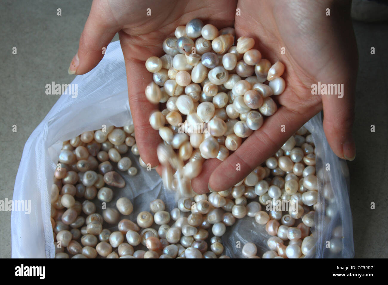 People holding pearls in both hands Stock Photo - Alamy