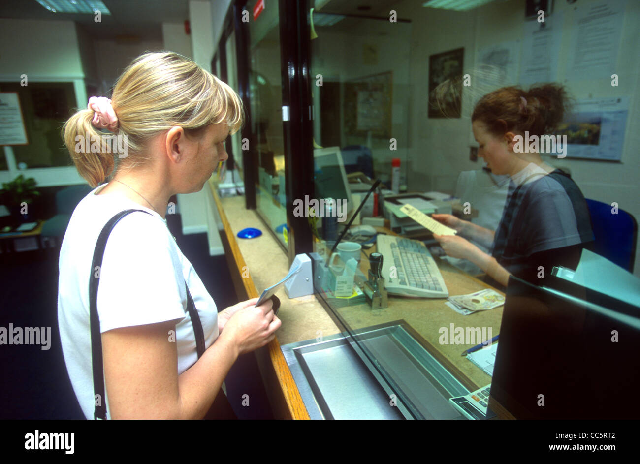 Female council tenant paying her rent at housing office, Maidstone ...