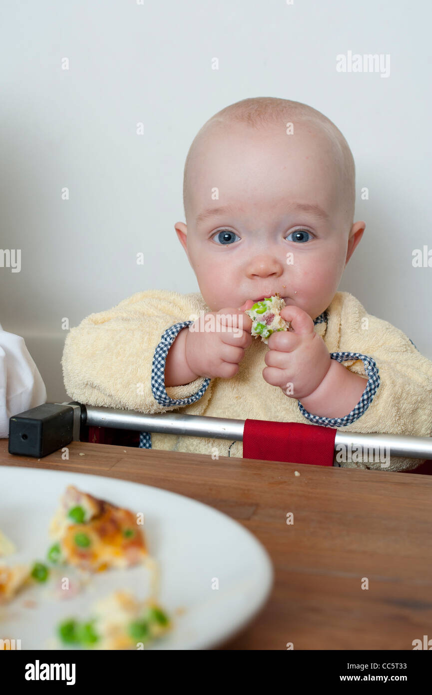 Baby Boy feeding himself Stock Photo - Alamy