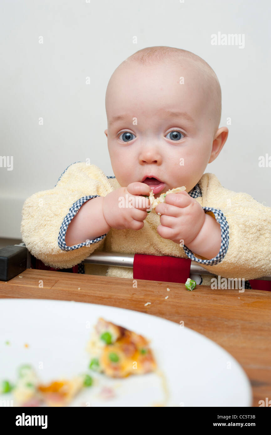 Baby Boy feeding himself Stock Photo - Alamy