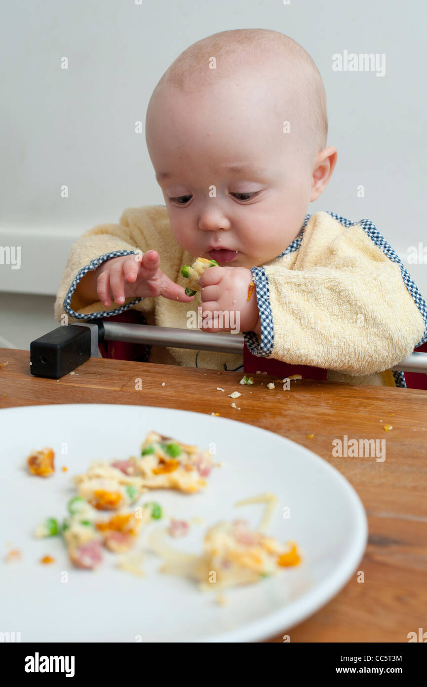 Baby Boy feeding himself Stock Photo - Alamy