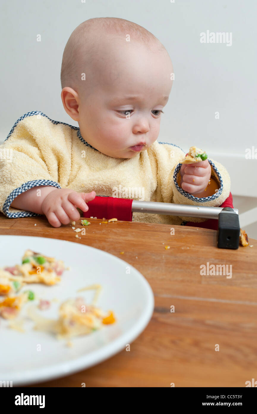 Baby Boy feeding himself Stock Photo - Alamy