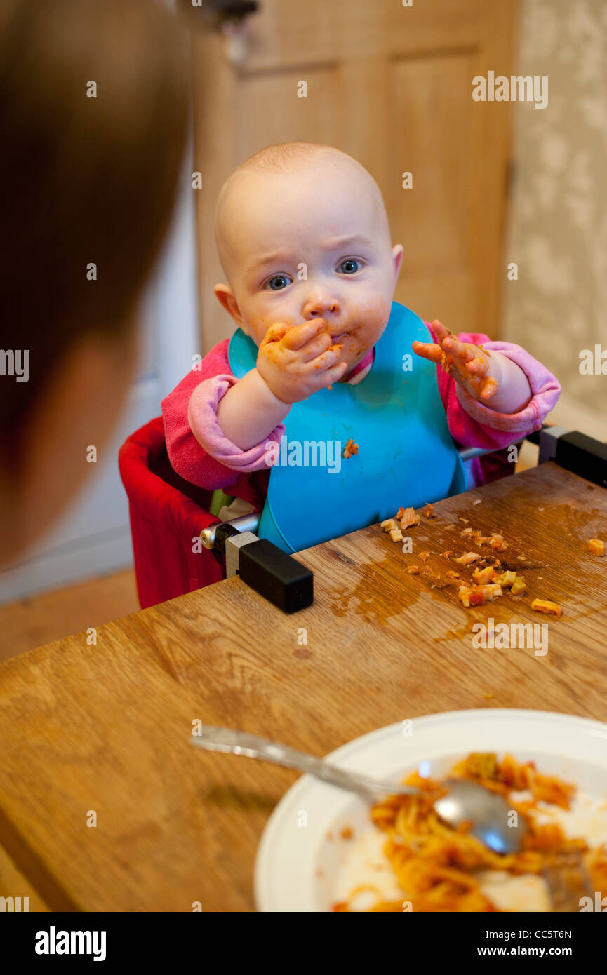 Baby Boy feeding himself Stock Photo - Alamy