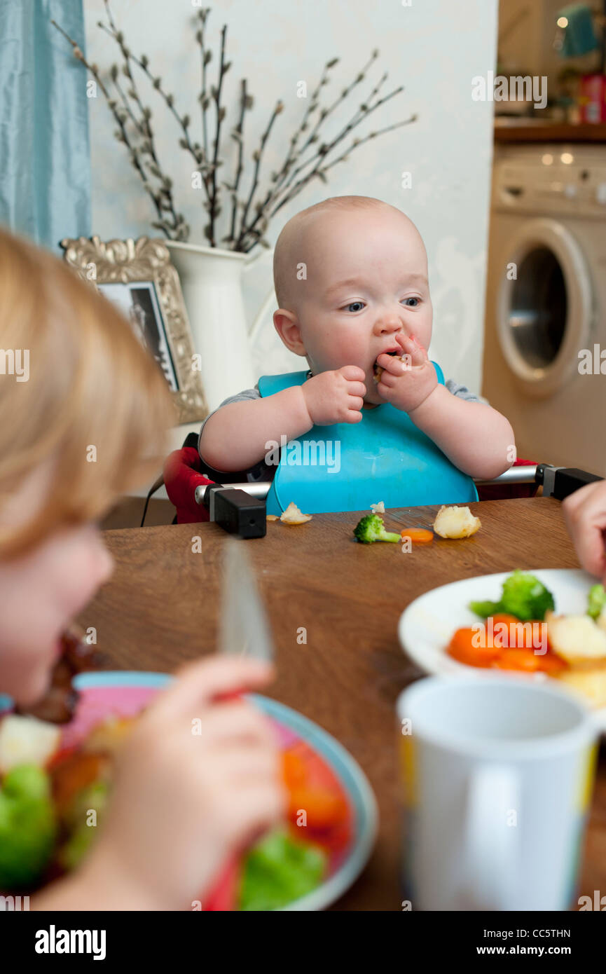 Baby Boy feeding himself Stock Photo - Alamy