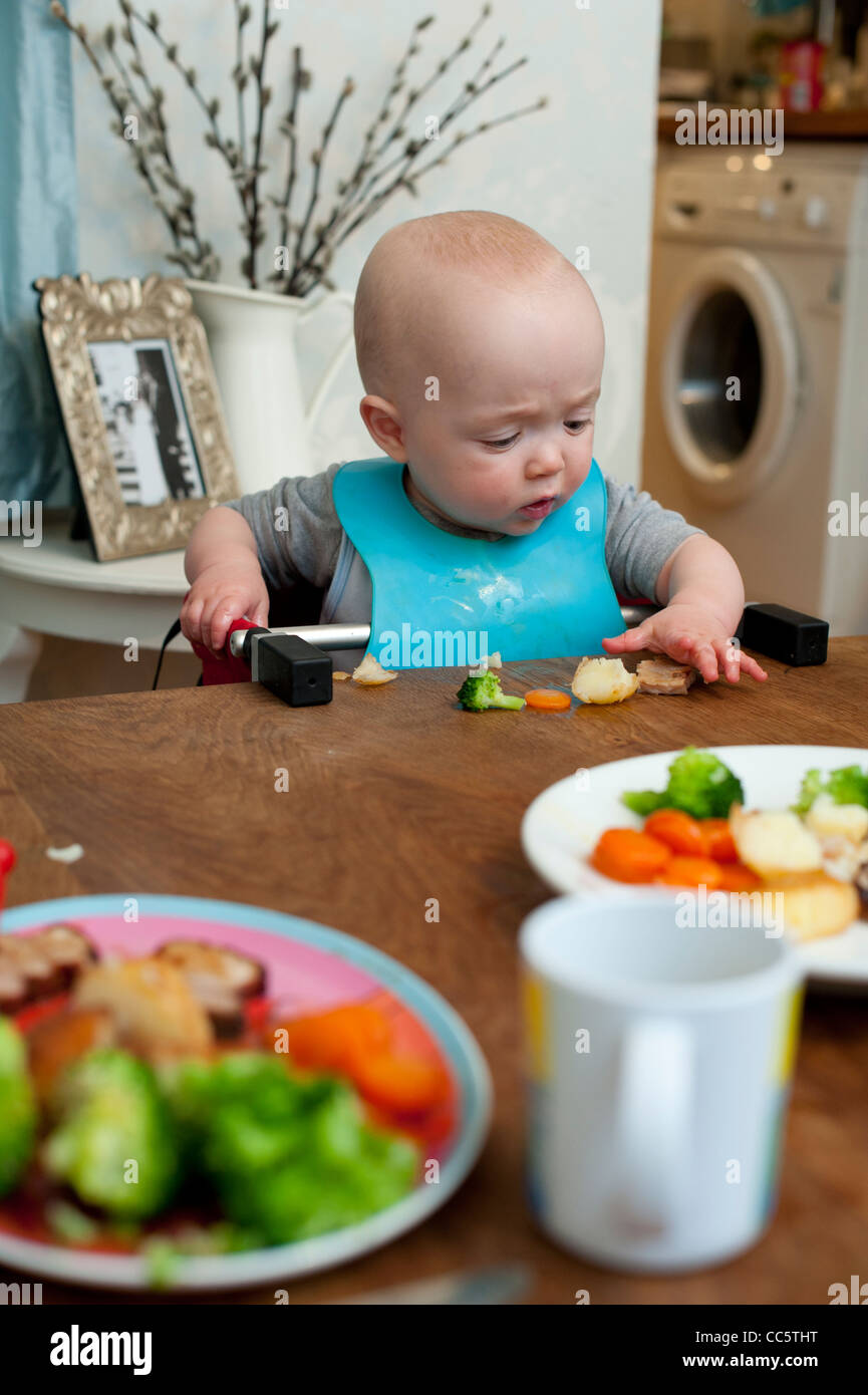 Baby Boy feeding himself Stock Photo - Alamy