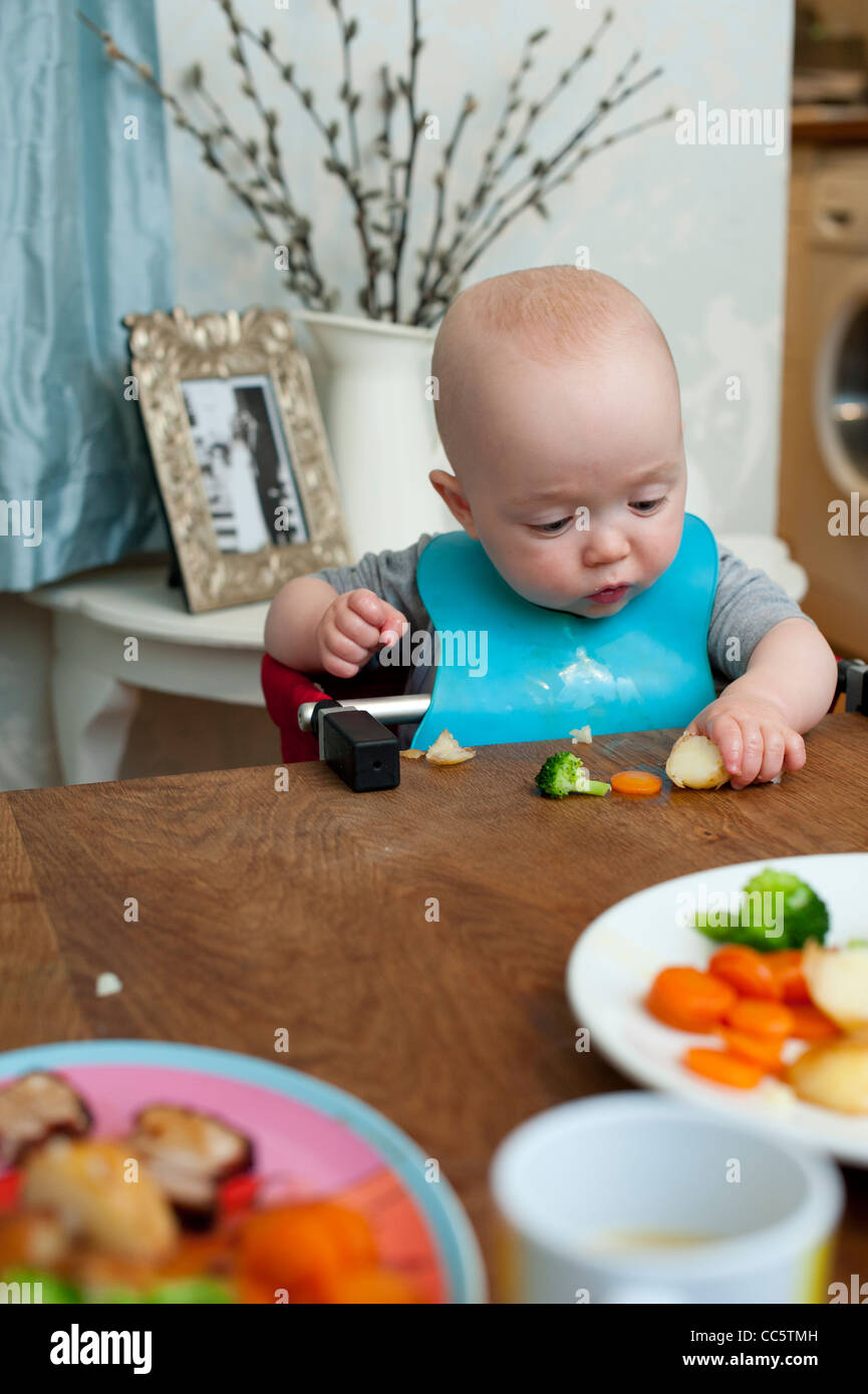 Baby Boy feeding himself Stock Photo - Alamy