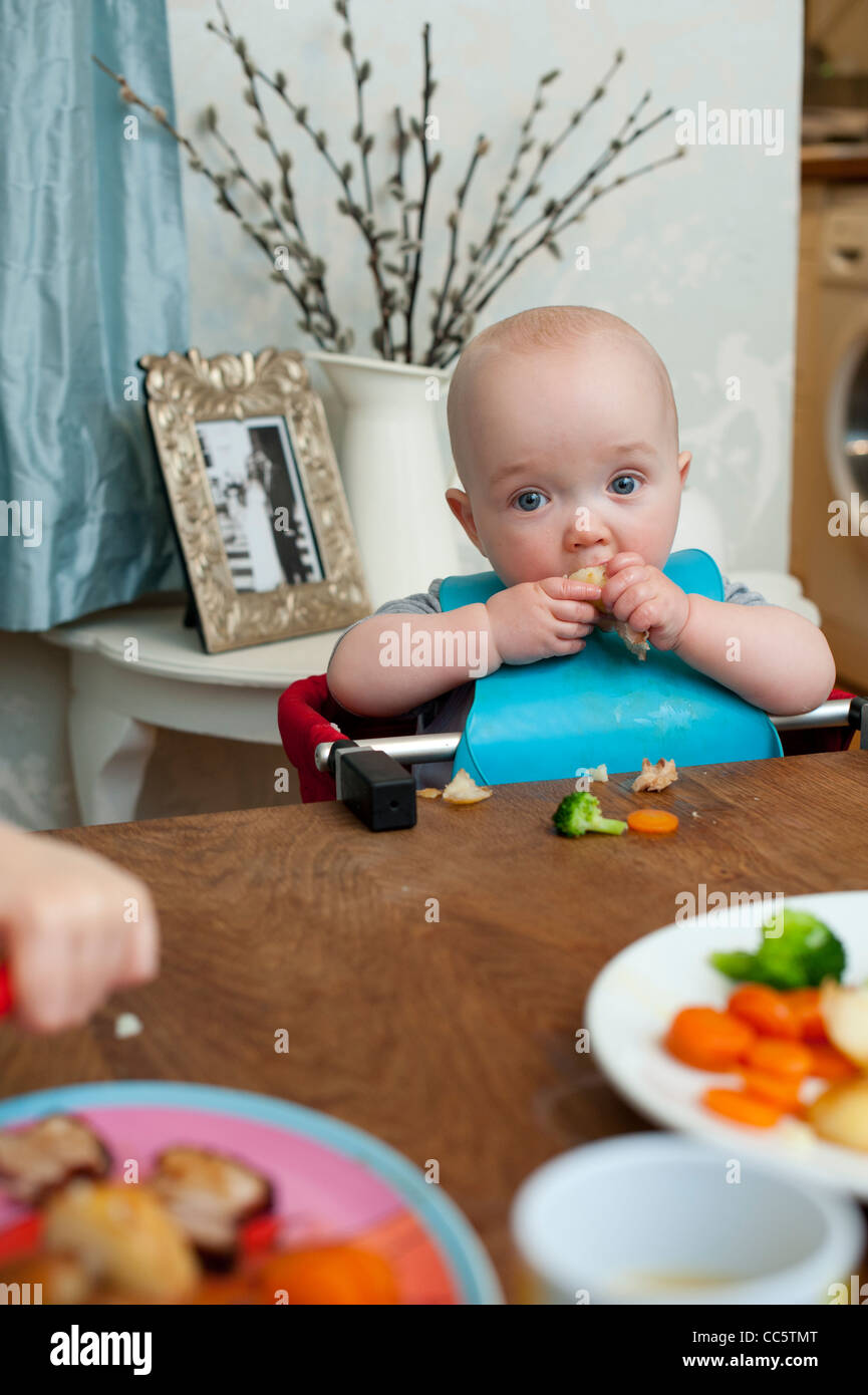 Baby Boy feeding himself Stock Photo - Alamy