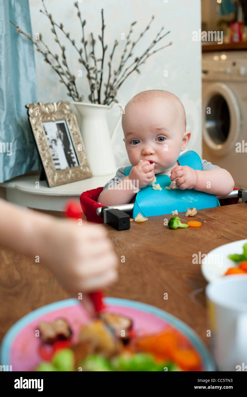 Baby Boy feeding himself Stock Photo - Alamy
