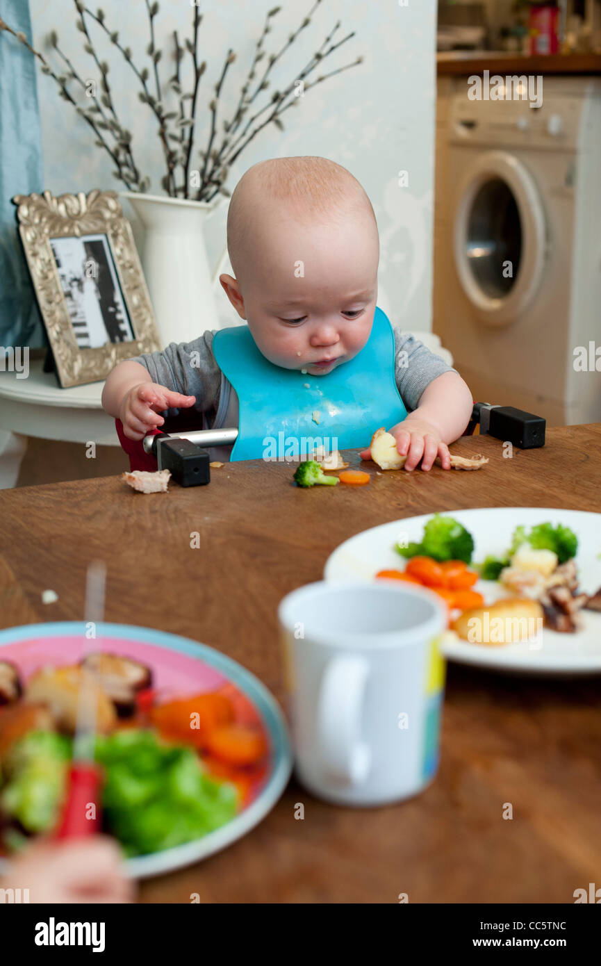 Baby Boy feeding himself Stock Photo - Alamy