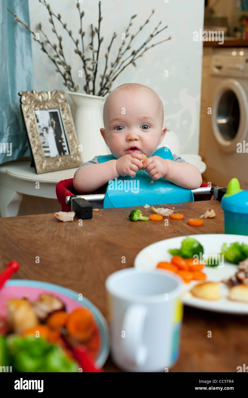 Baby Boy feeding himself Stock Photo - Alamy