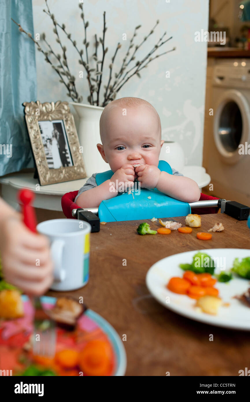 Baby Boy feeding himself Stock Photo - Alamy