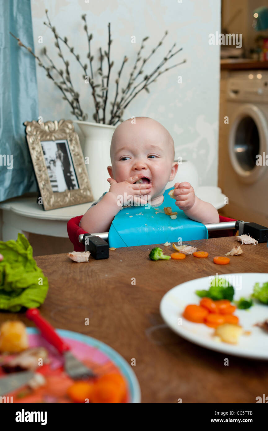Baby Boy feeding himself Stock Photo - Alamy