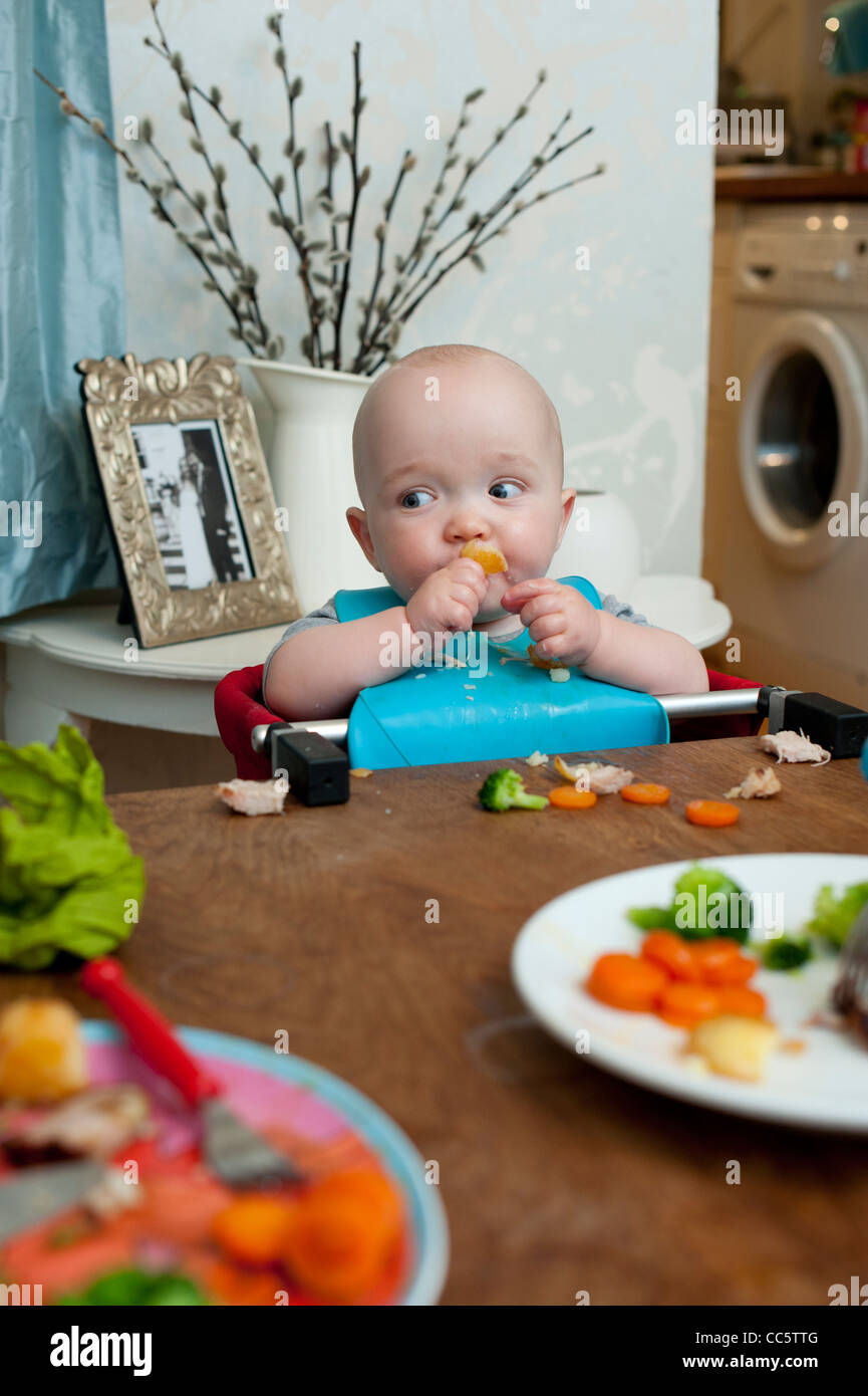 Baby Boy feeding himself Stock Photo - Alamy