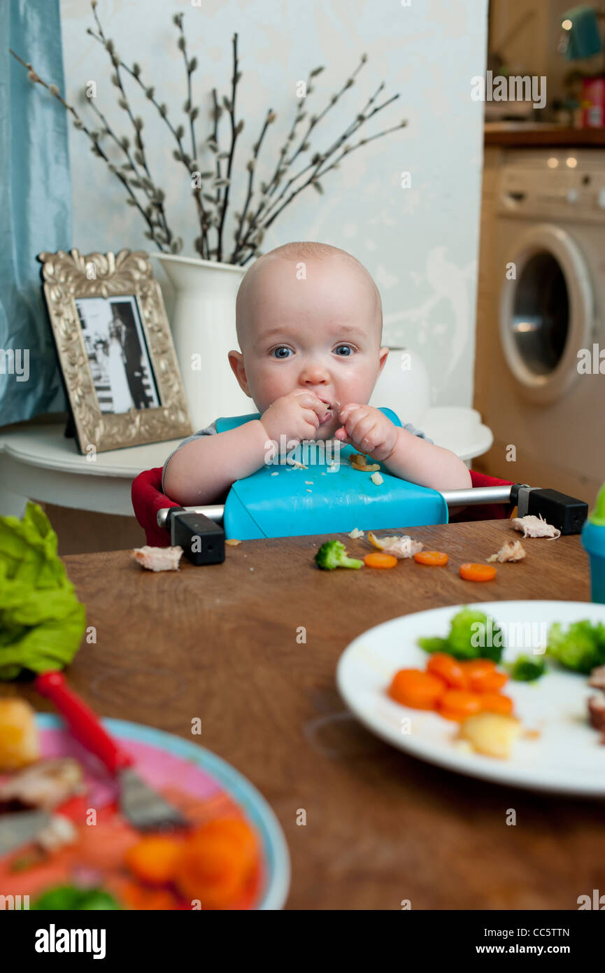 Baby Boy feeding himself Stock Photo - Alamy