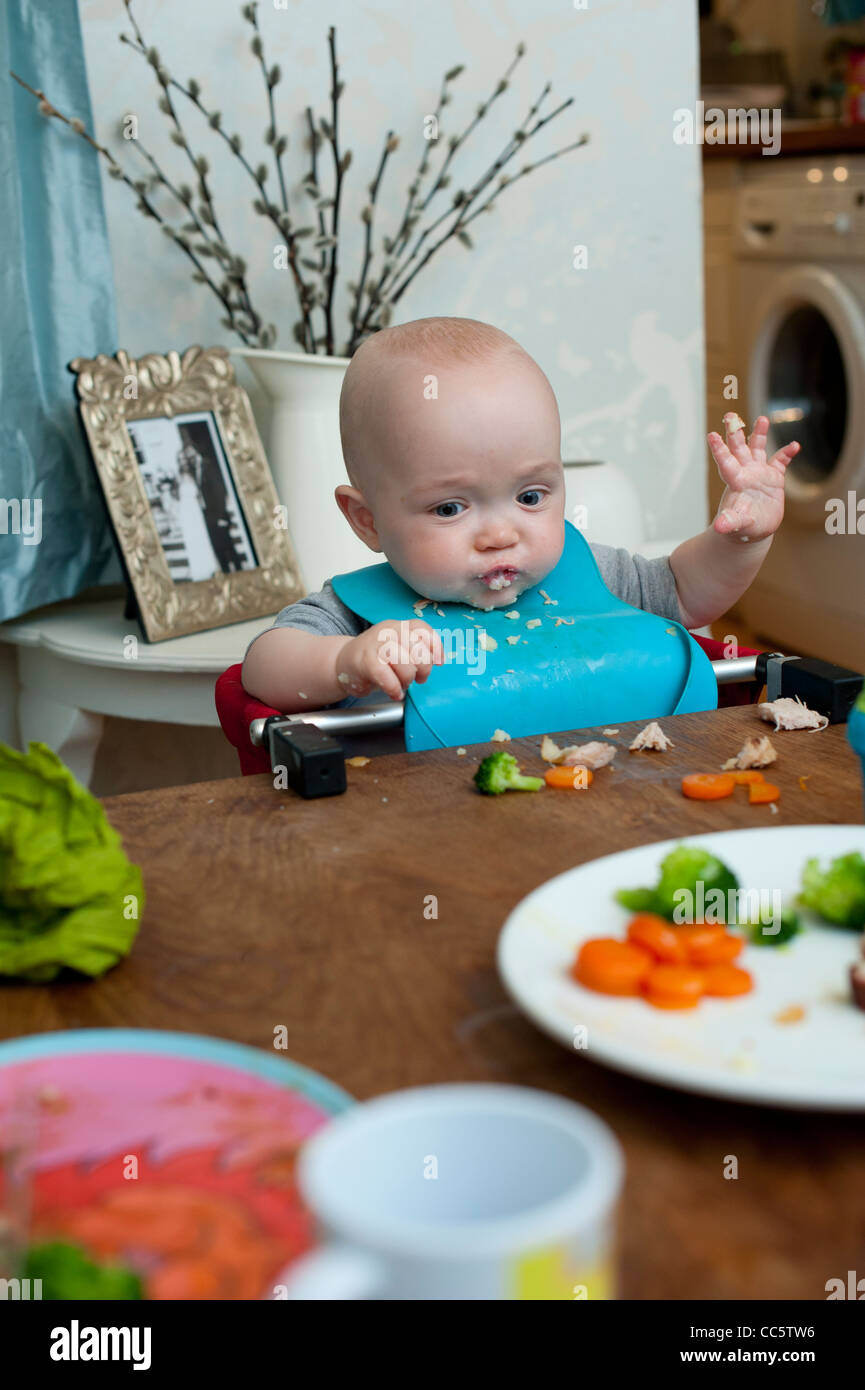 Baby Boy feeding himself Stock Photo - Alamy