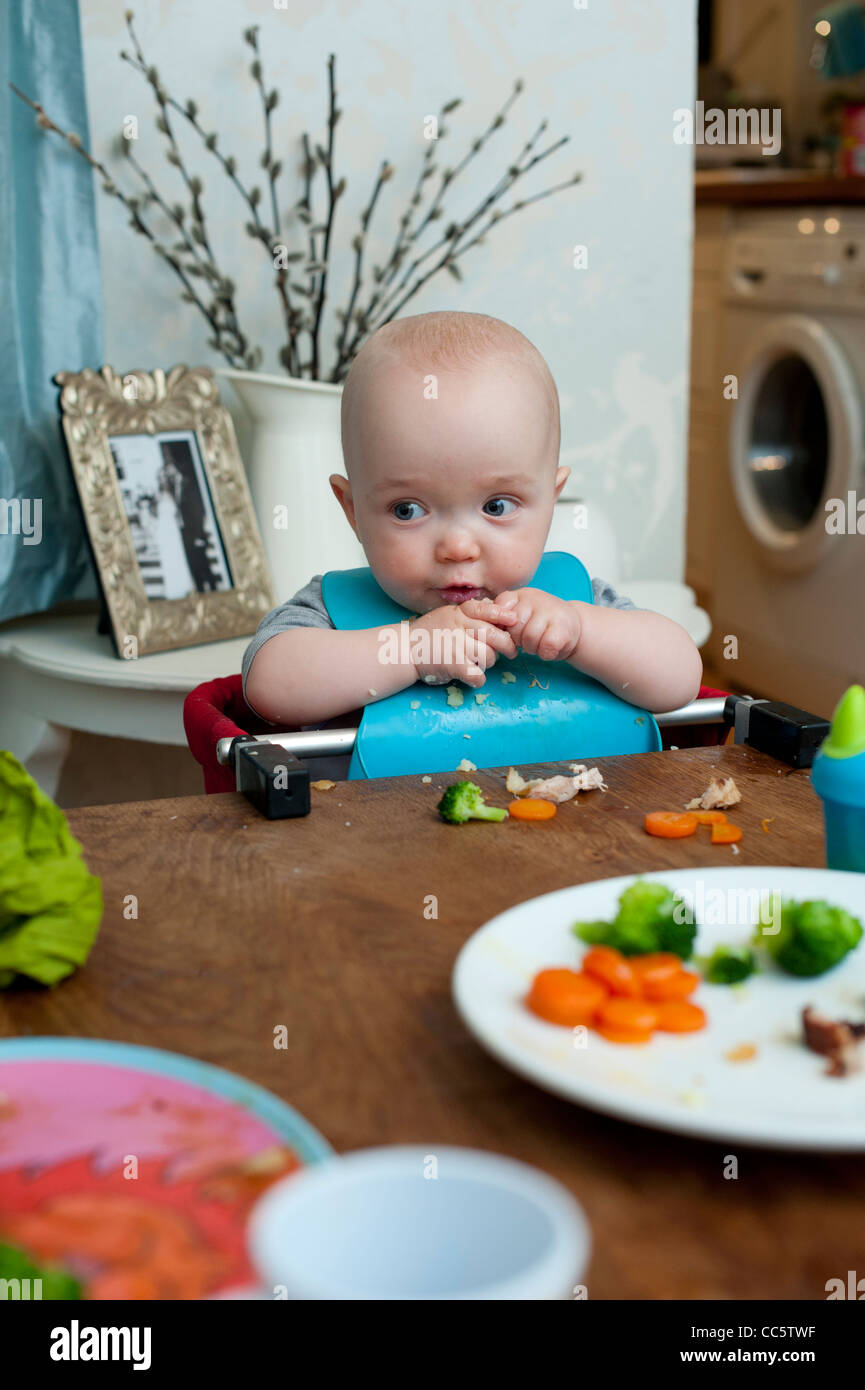 Baby Boy feeding himself Stock Photo - Alamy