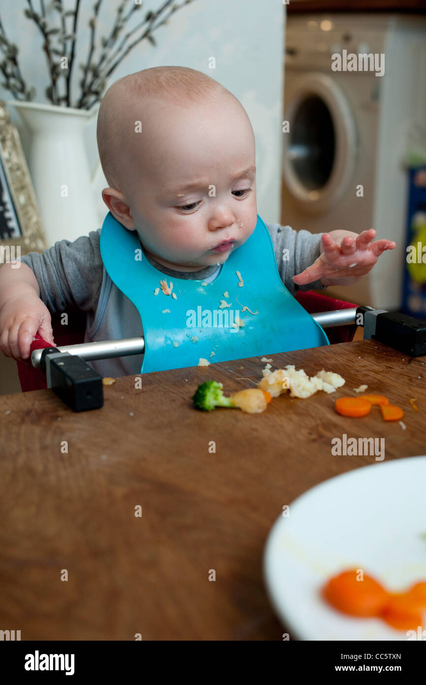 Baby Boy feeding himself Stock Photo - Alamy