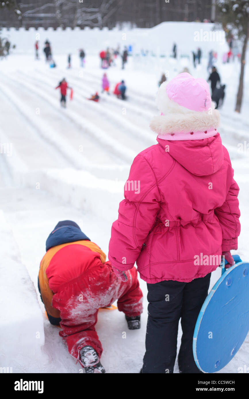 Children on ice slope in park Stock Photo - Alamy