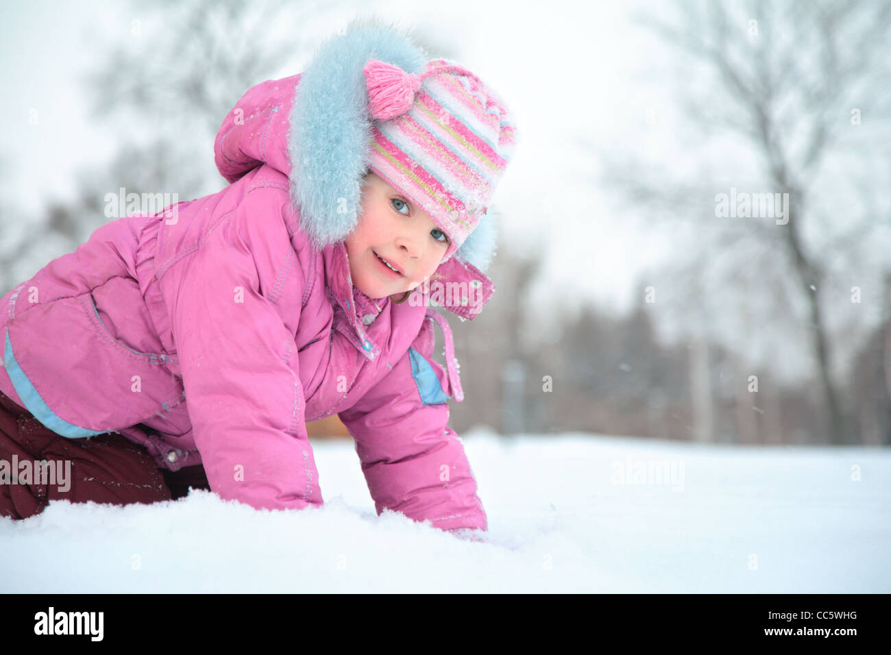 Little girl on snow Stock Photo - Alamy