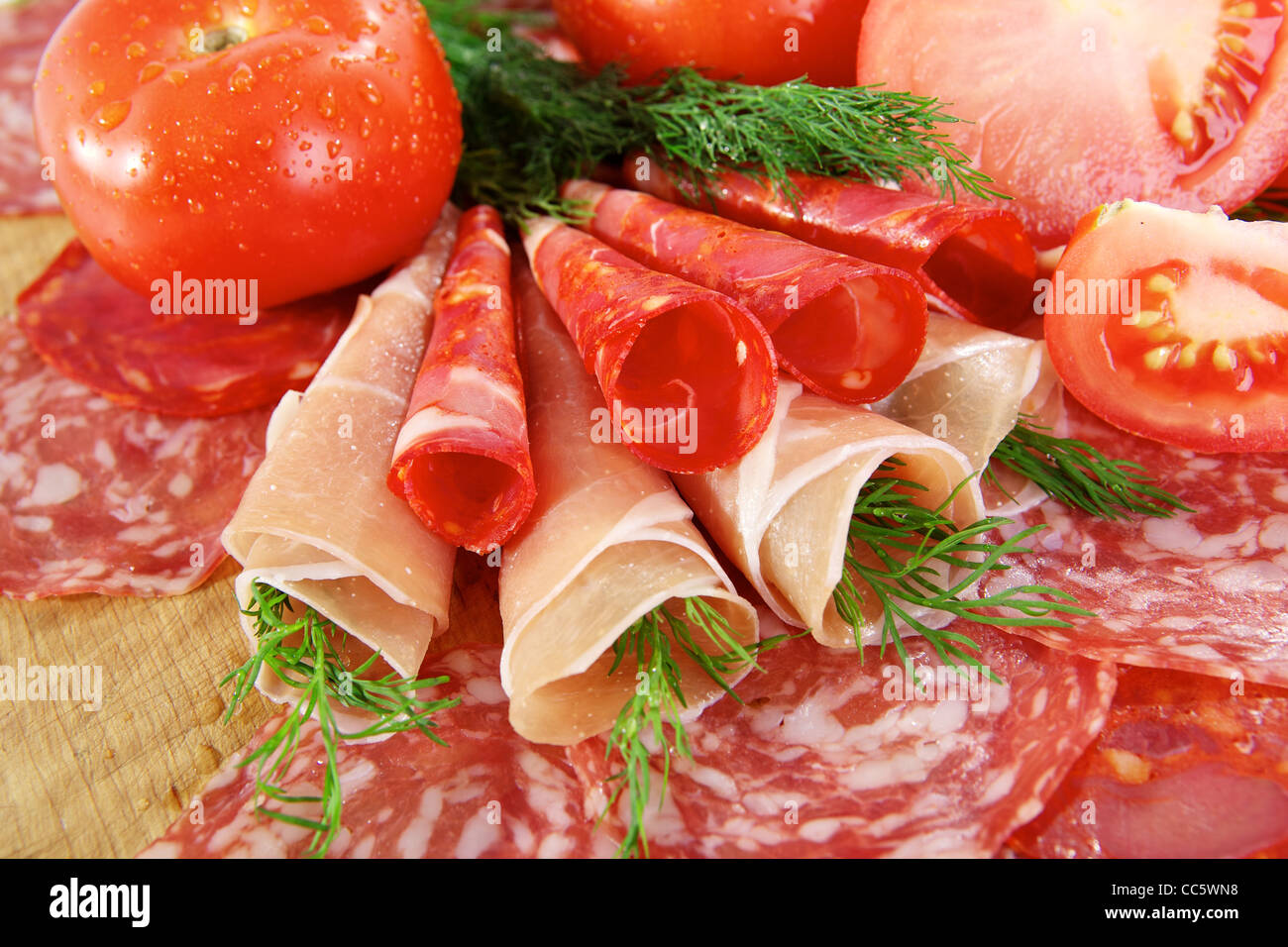 Smoked meat and salami on a wooden board Stock Photo - Alamy