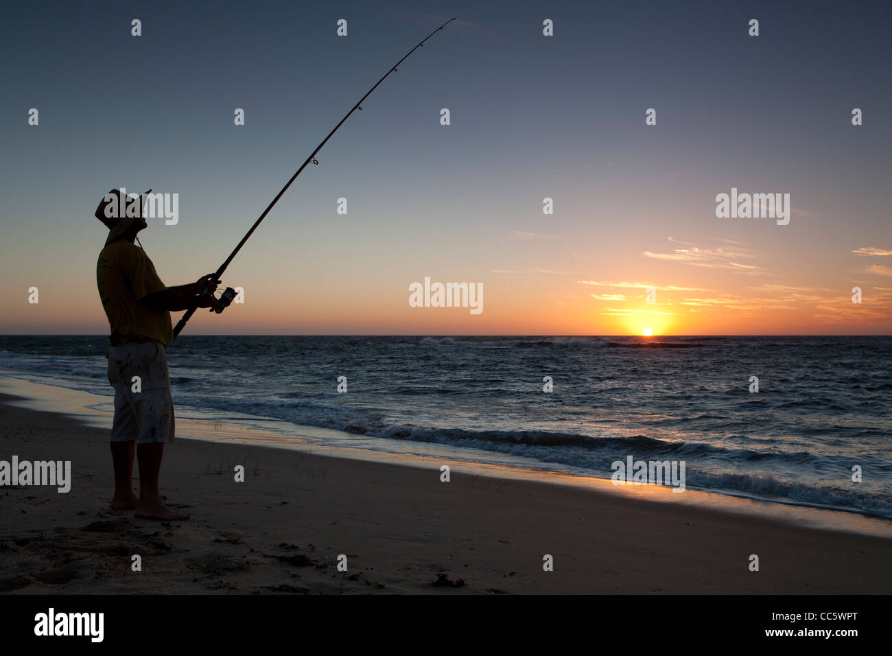 A fisherman beach casting on the coast of Dongara, Western Australia ...