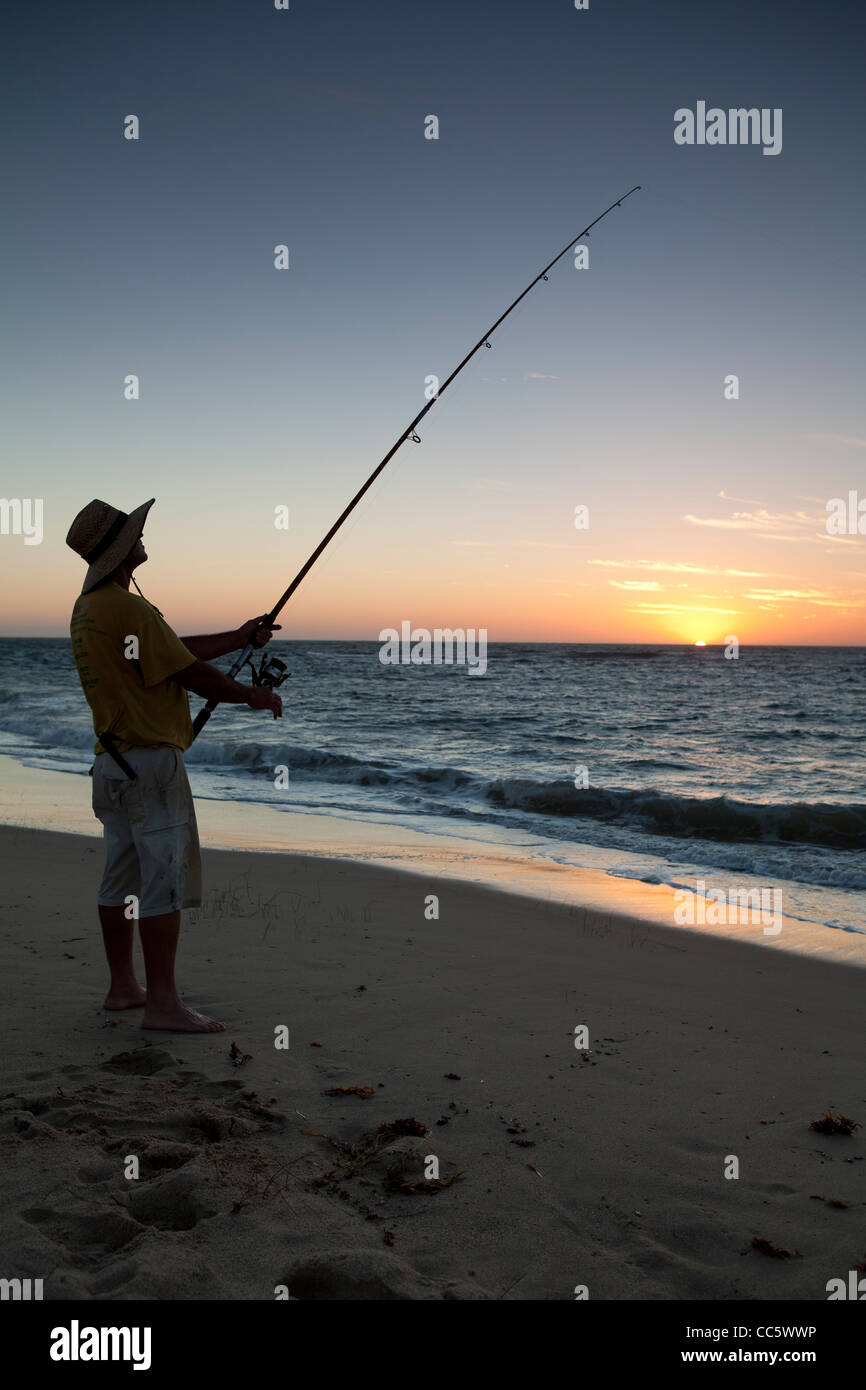 A fisherman beach casting on the coast of Dongara, Western Australia ...