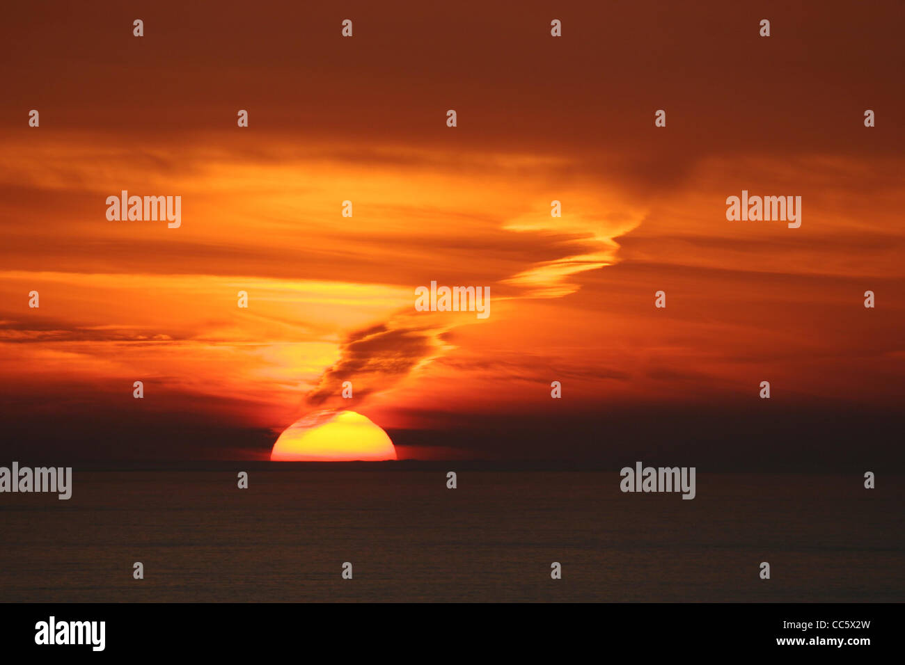 A dramatic sunset over the Atlantic Ocean at Bossiney Cove on the North ...