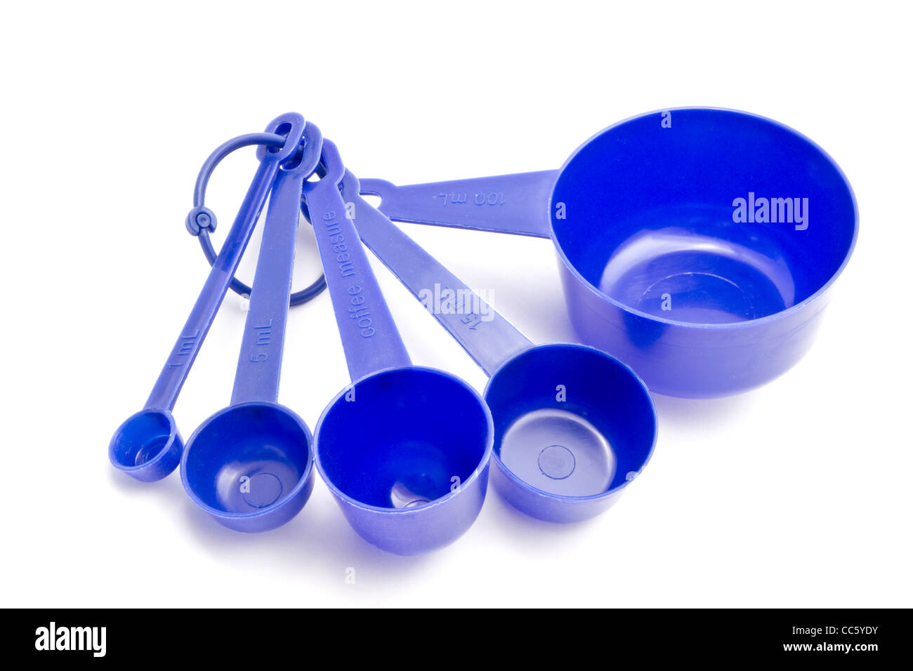 Blue measuring spoons closeup on white background Stock Photo - Alamy