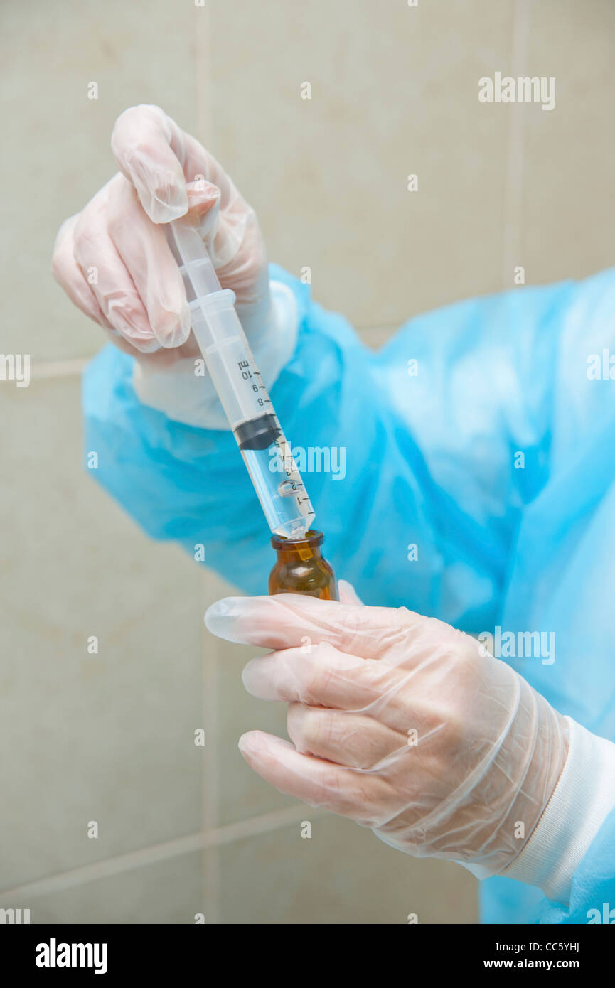 Lab technician with gloves and protective clothing Stock Photo - Alamy