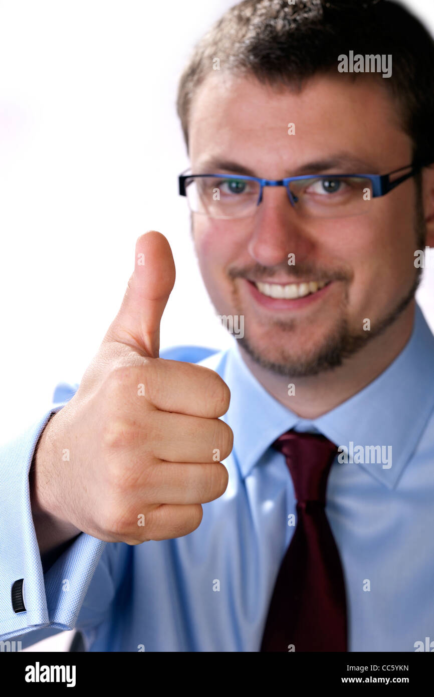 Happy business manager smiles positively and gives the thumb up Stock ...