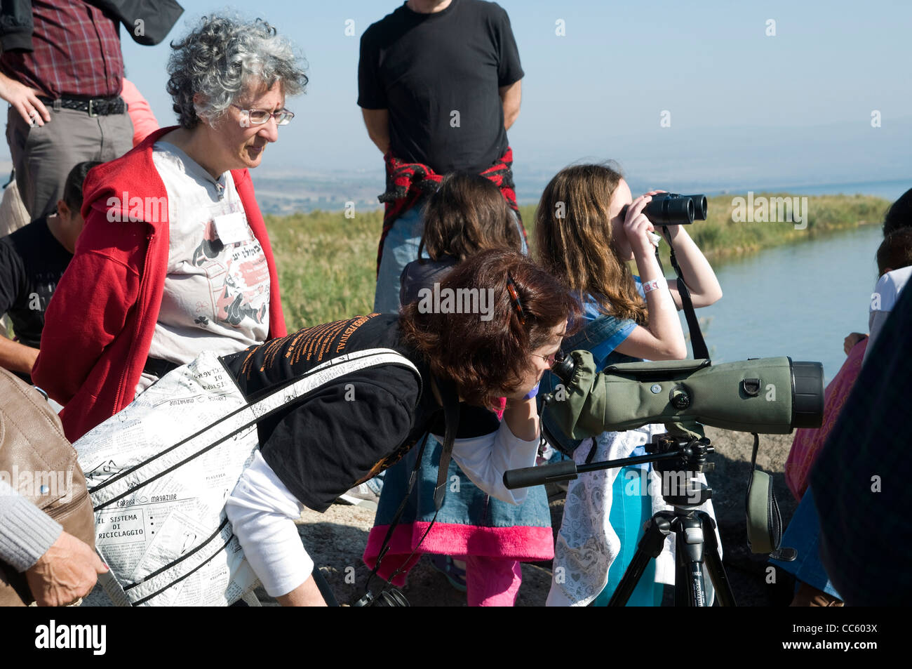 A group of people birdwatching. Photographed on the shores of the Sea ...