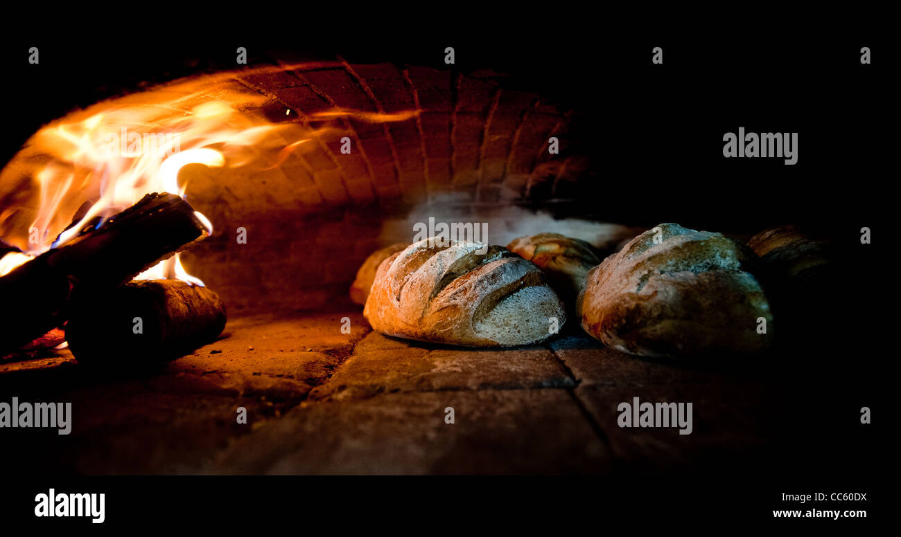 Bread being baked in a traditional style oven Stock Photo - Alamy