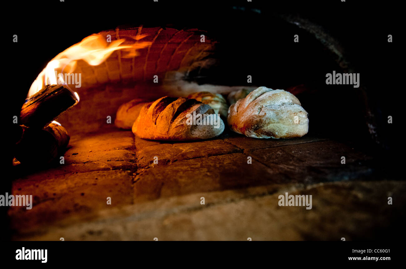 Bread being baked in a traditional style oven Stock Photo - Alamy