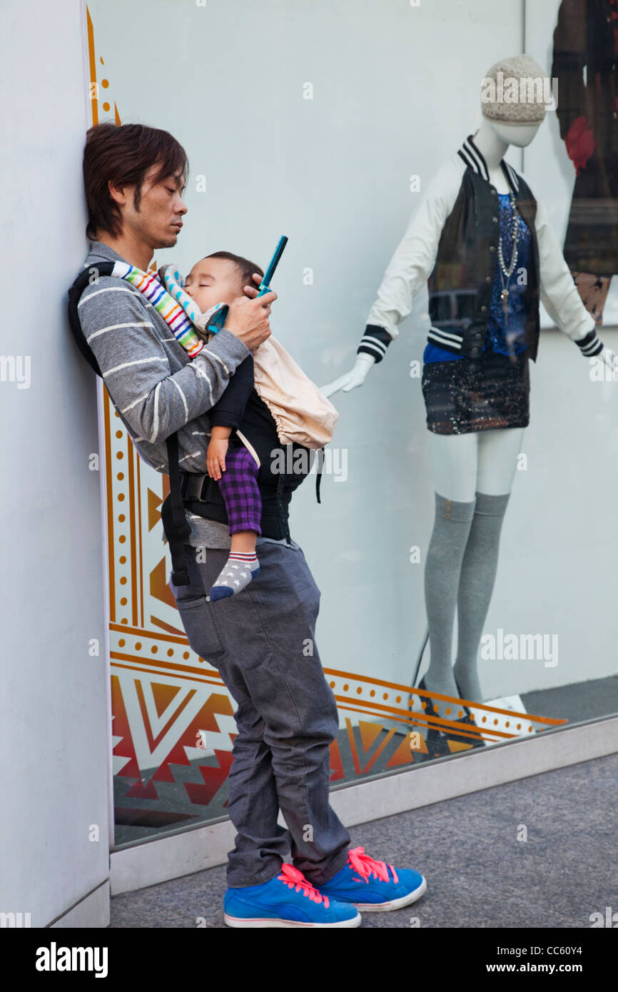 Japan, Tokyo, Harajuku, Takeshita Dori, Man Holding Baby and Mobile ...