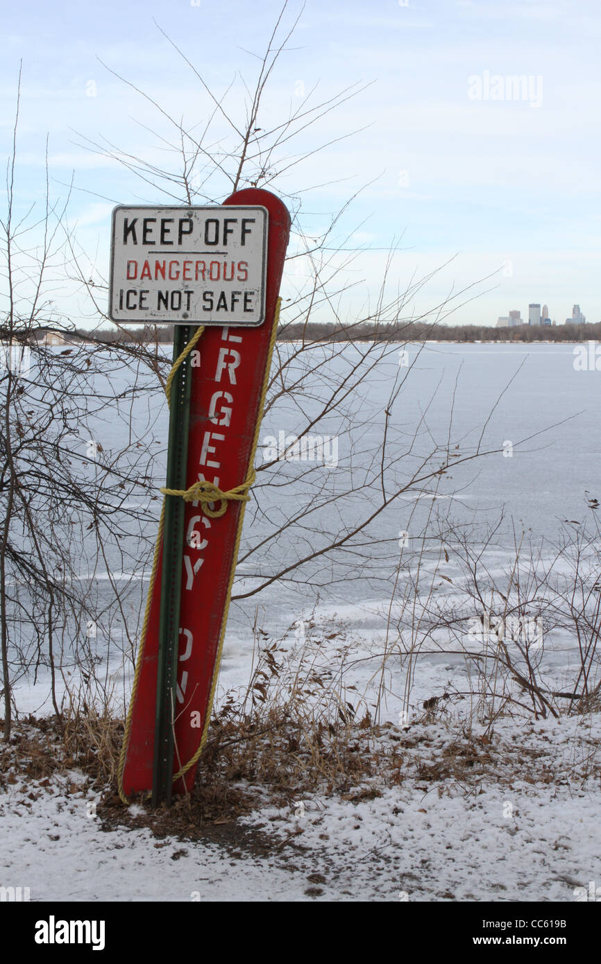 A sign warning of dangerous conditions on the ice on a lake in ...