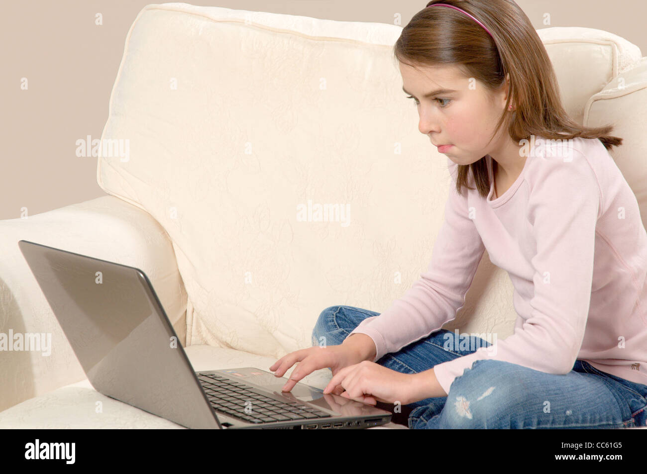 Young girl operating a laptop computer Stock Photo - Alamy