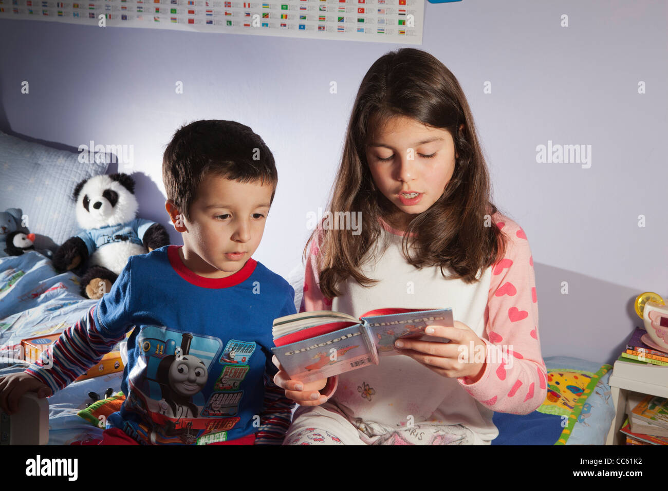 Close-up of siblings reading bedtime stories together Stock Photo - Alamy
