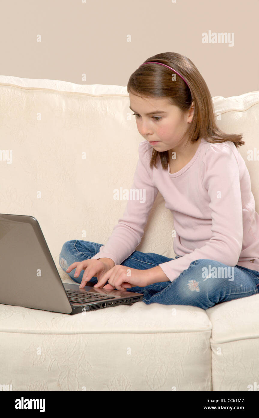 Young girl operating a laptop computer Stock Photo - Alamy