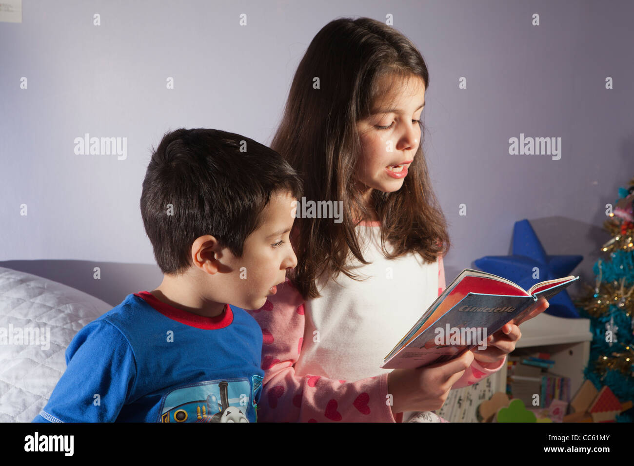 Brother sister reading bedtime story hi-res stock photography and ...