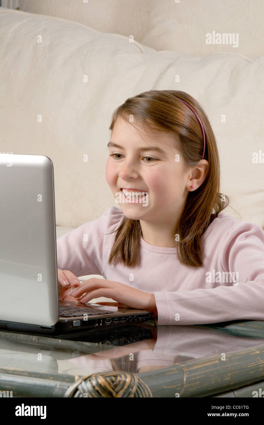 Young girl operating a laptop computer Stock Photo - Alamy