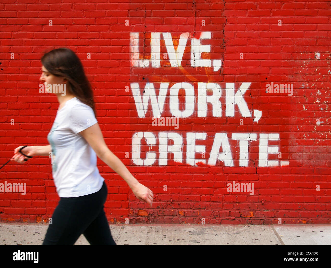 The words Live, Work, Create spray painted onto red brick wall in ...