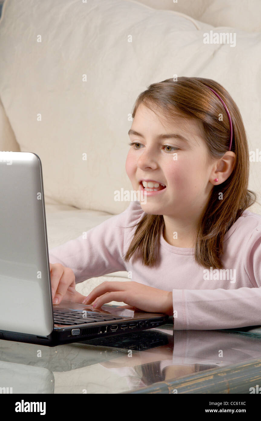 Young girl operating a laptop computer Stock Photo - Alamy