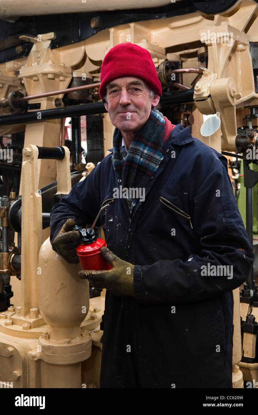 Roy Mitchell, engineer working on a ship's engine from a dredger Stock ...