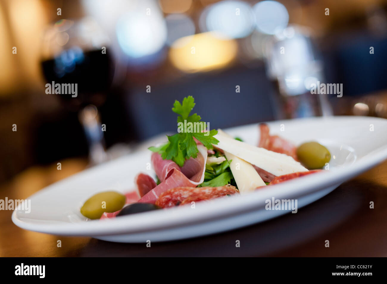 Italian ham, cheese and olives with a glass of red wine Stock Photo - Alamy