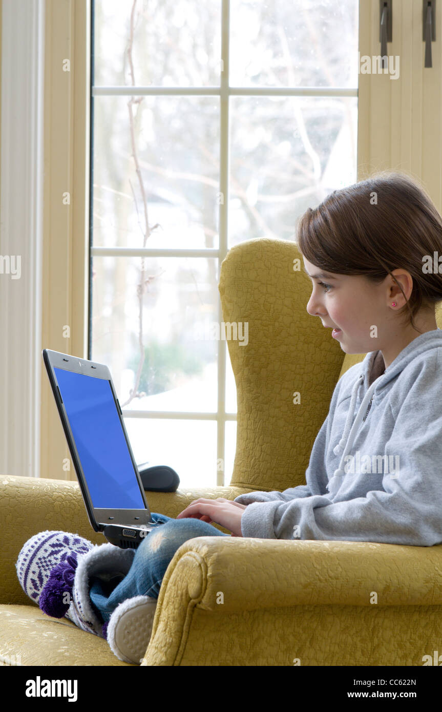 Young girl operating a laptop computer Stock Photo - Alamy