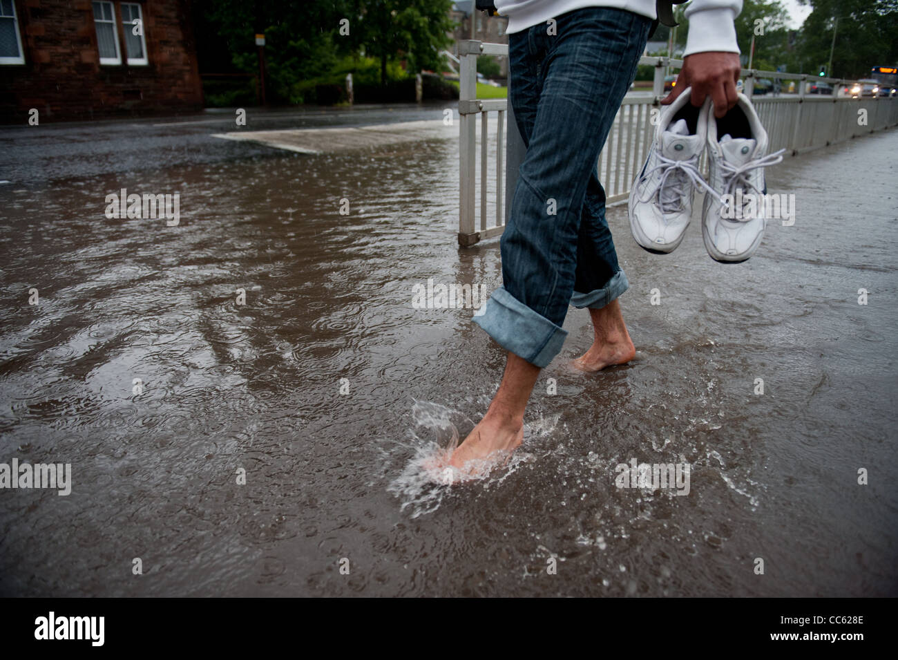 Woman wading through flood river hi-res stock photography and images ...