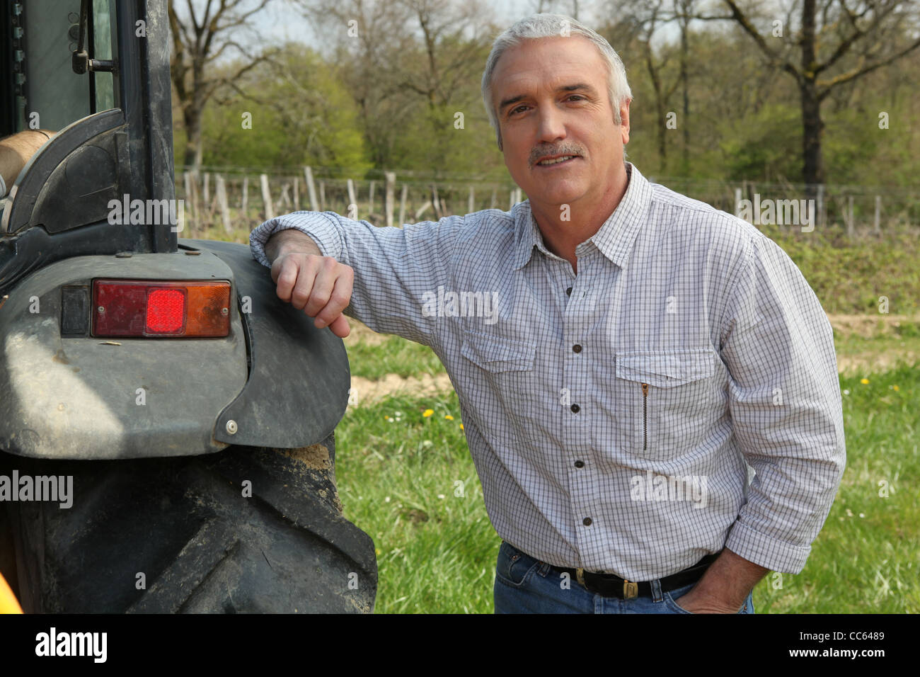 Man leaning against tractor hi-res stock photography and images - Alamy