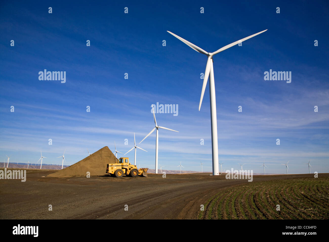 Wind turbines dot the horizon at wind farms along the Columbia River ...